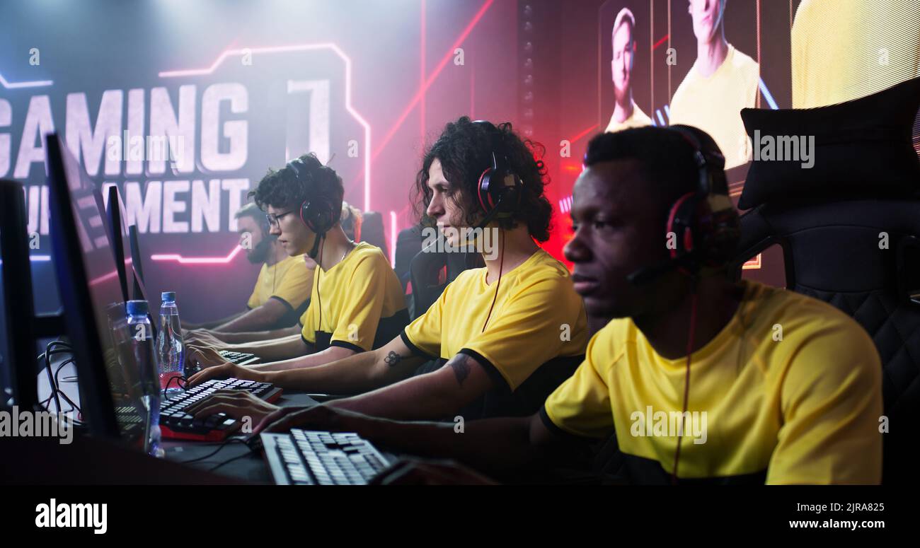 Multiracial male gamers esportsman putting on headsets and starting to ...