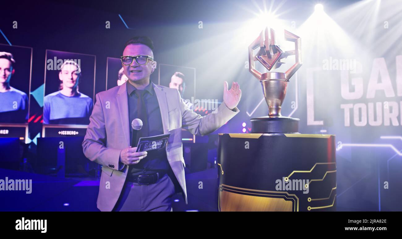 Man host with microphone walking and talking to audience while ...