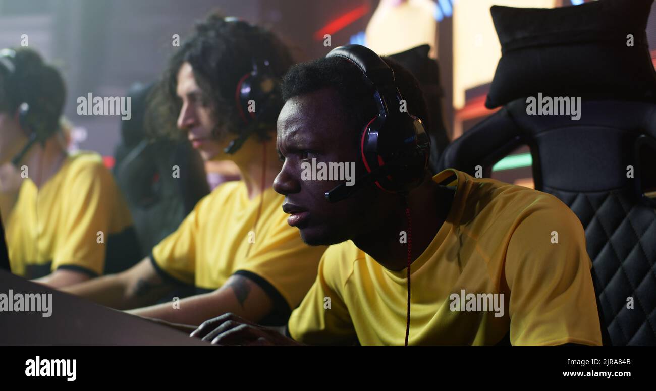 Exhausted multiracial esports players gamers playing video game on ...