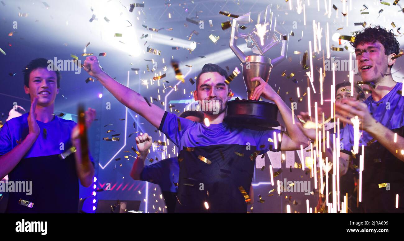 Esport gamers team with golden trophy celebrating victory amidst ...
