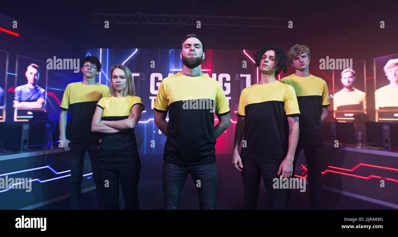 Assured team of teammates esportsman gamers in yellow uniform standing ...