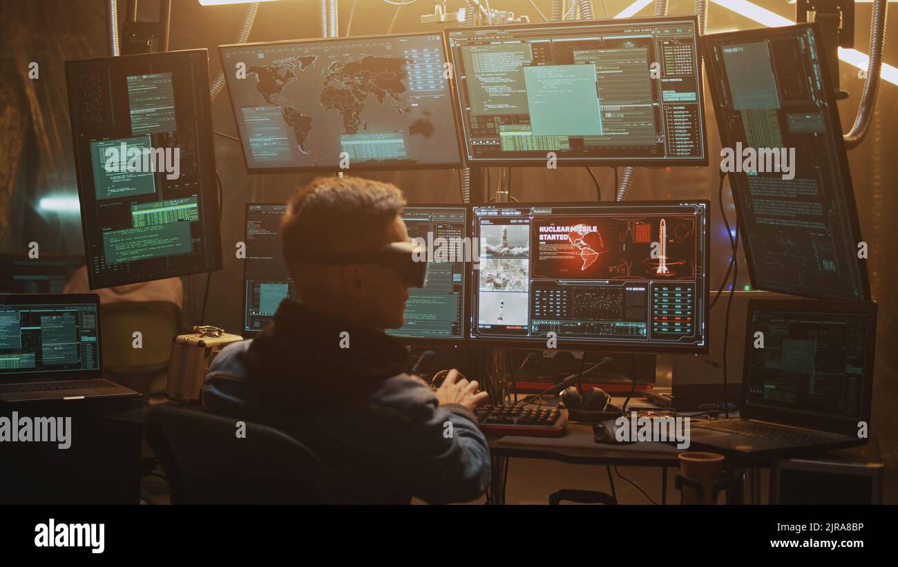 Cybercriminal in virtual reality glasses hacking and launching a nuclear missile by countdown ...