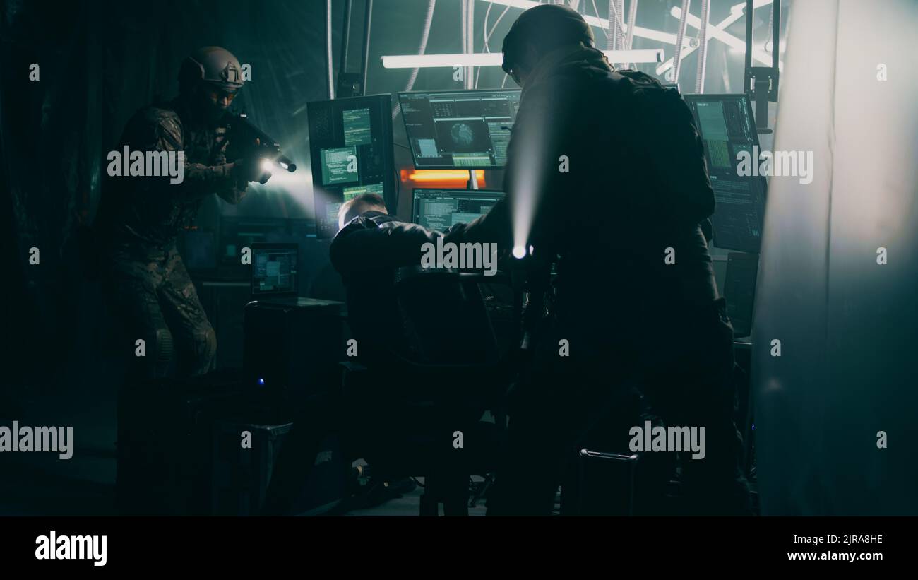Police tactical unit soldiers with guns arresting cyber criminal during ...
