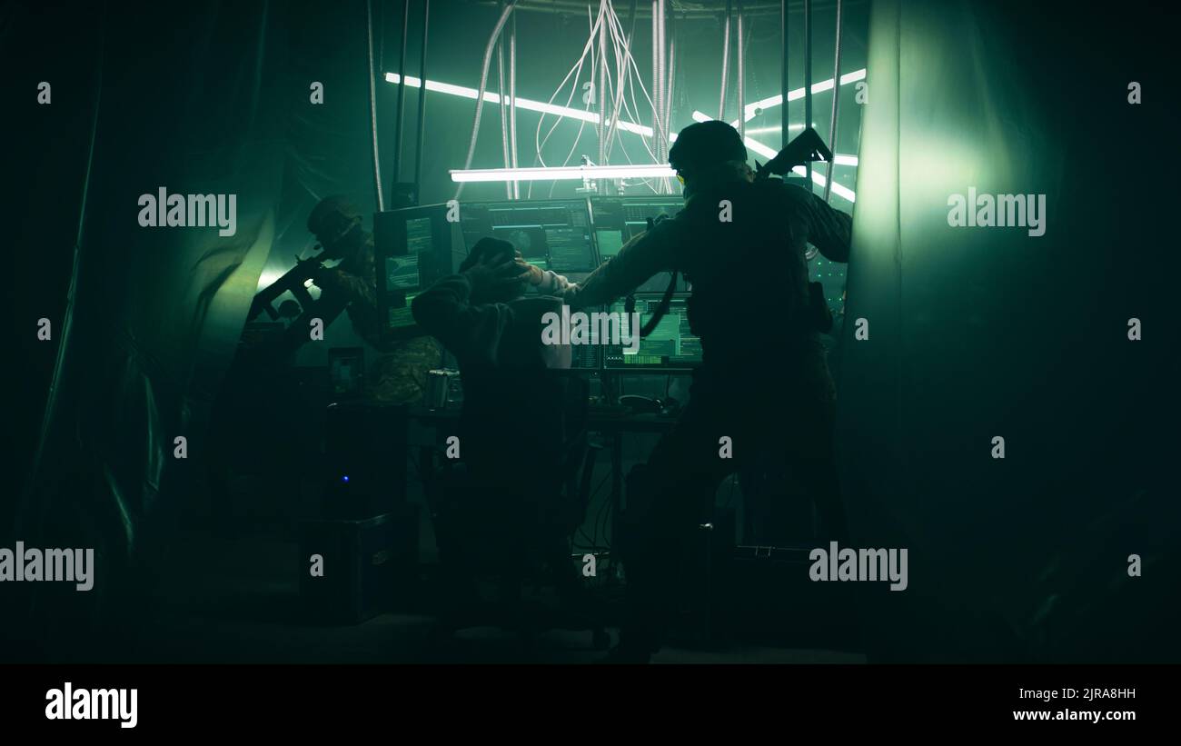 FBI officers in uniform with guns arresting group of cybercriminals in ...