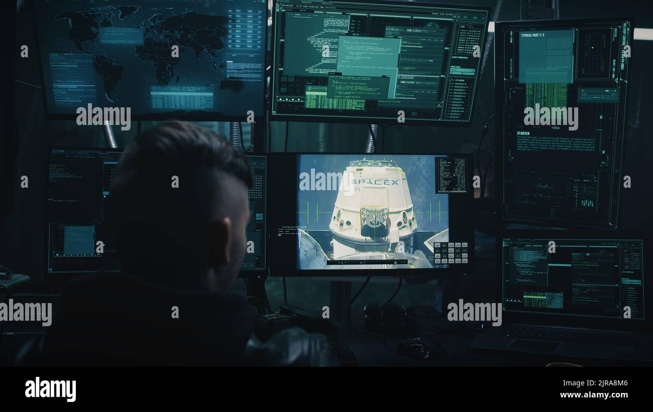 Male programmer using computer to control space unit and station ...