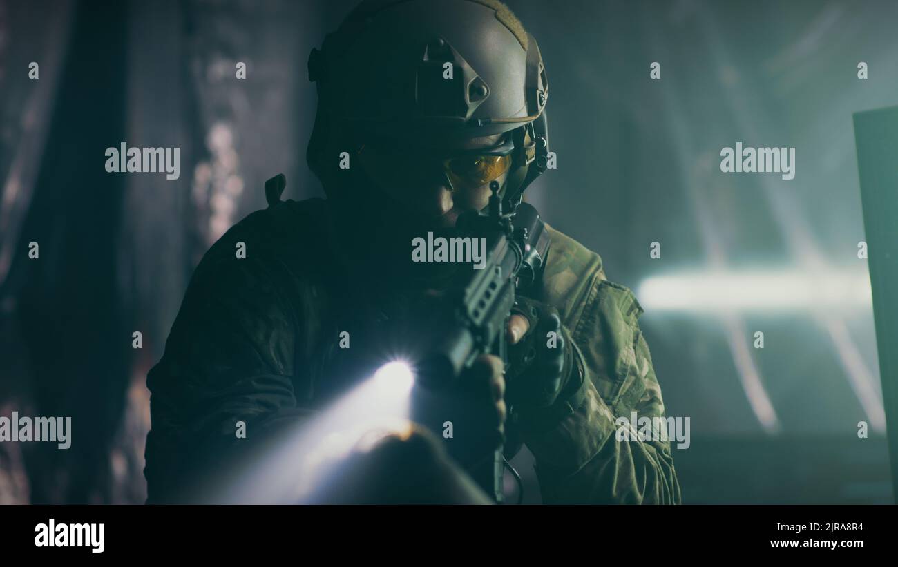 Angry tactical team soldier in helmet and goggles threatening hacker ...