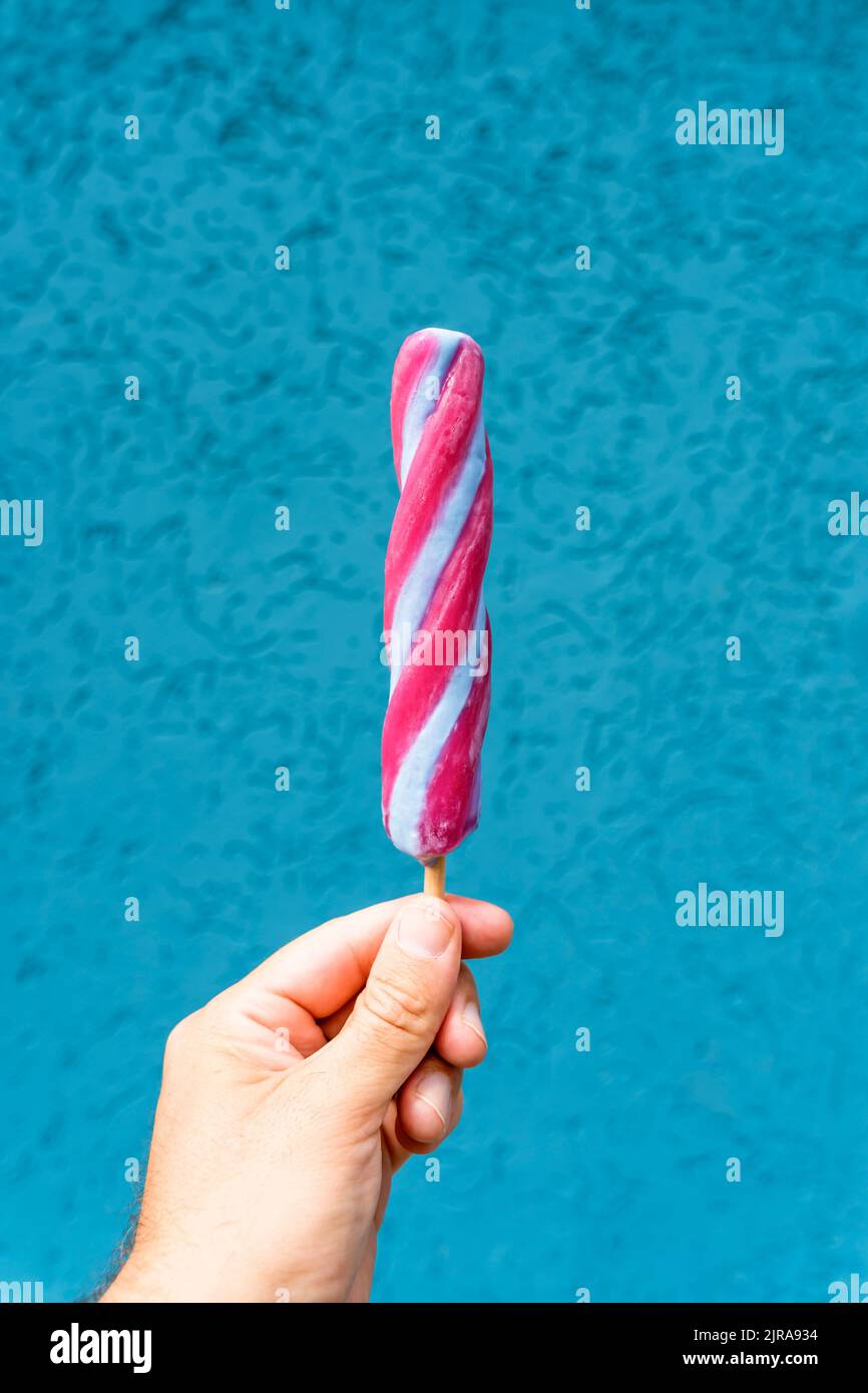 Ice cream cone in hand on minimal color background isolated. Summer ...