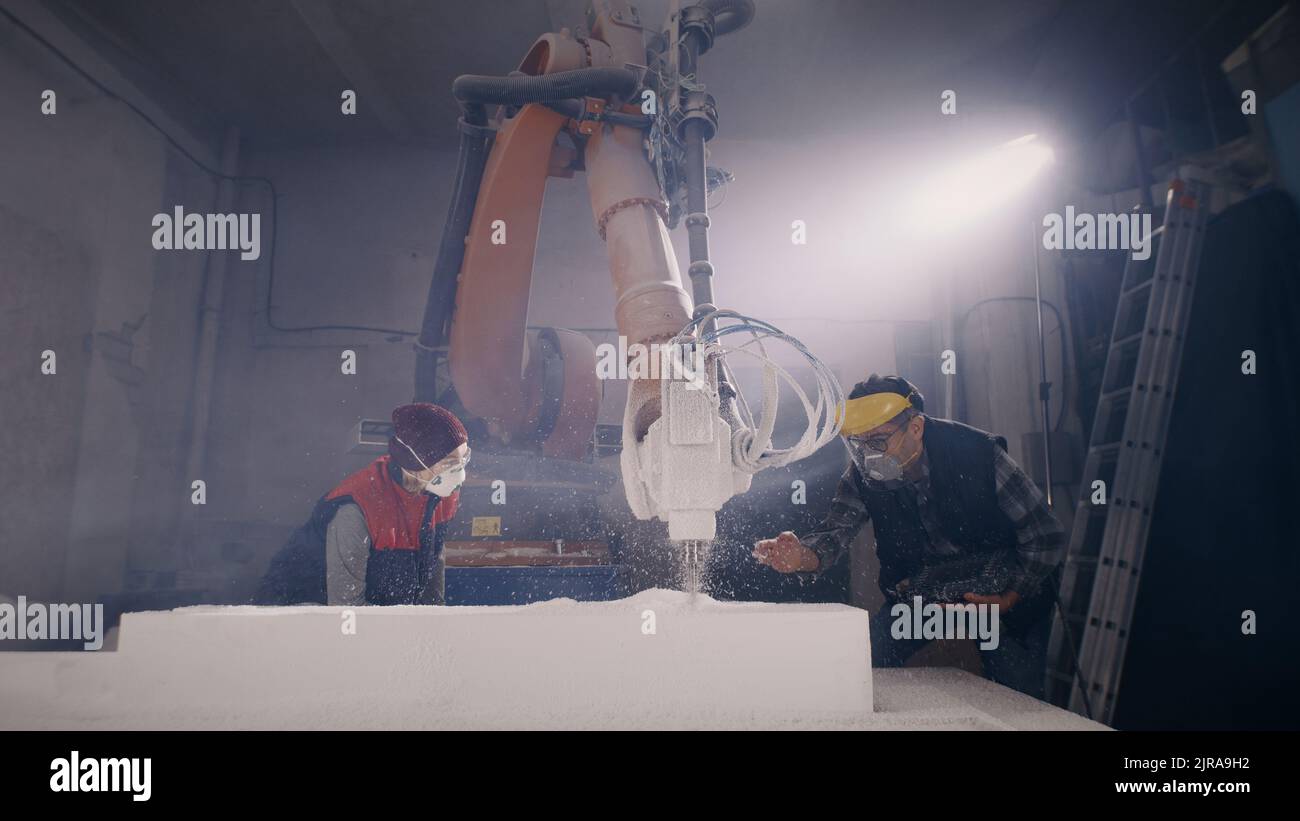 Zoom out view of man and woman in respirators and face mask discussing ...