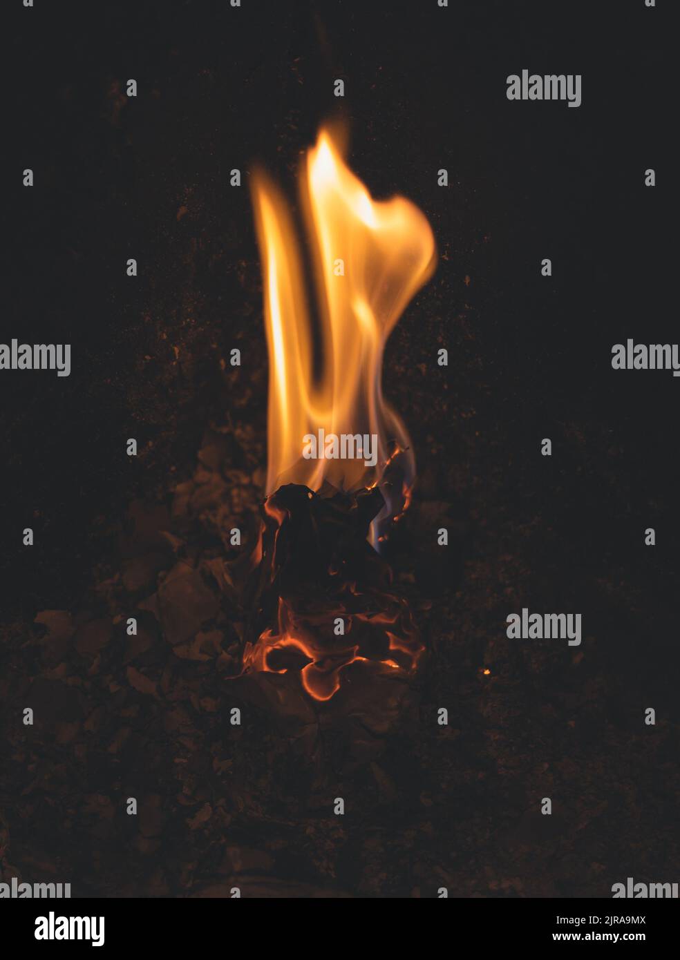 A vertical closeup of fire in the darkness Stock Photo - Alamy