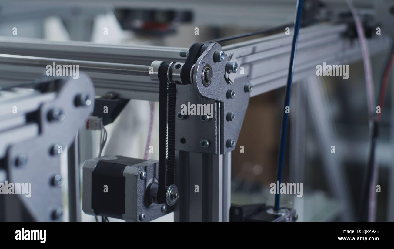 Soft focus of mechanism of contemporary 3D printer printing plastic ...