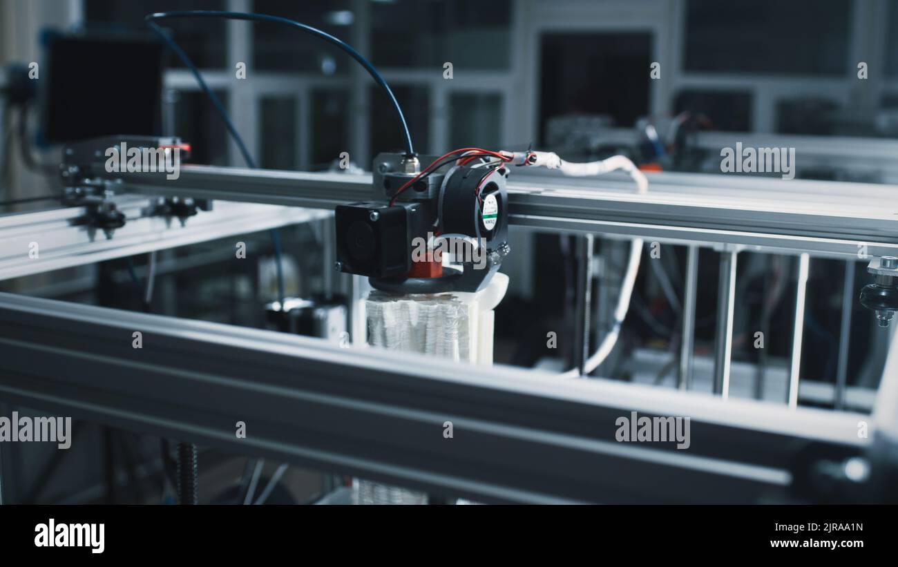 Modern 3D printer printing model from plastic in workshop of ...