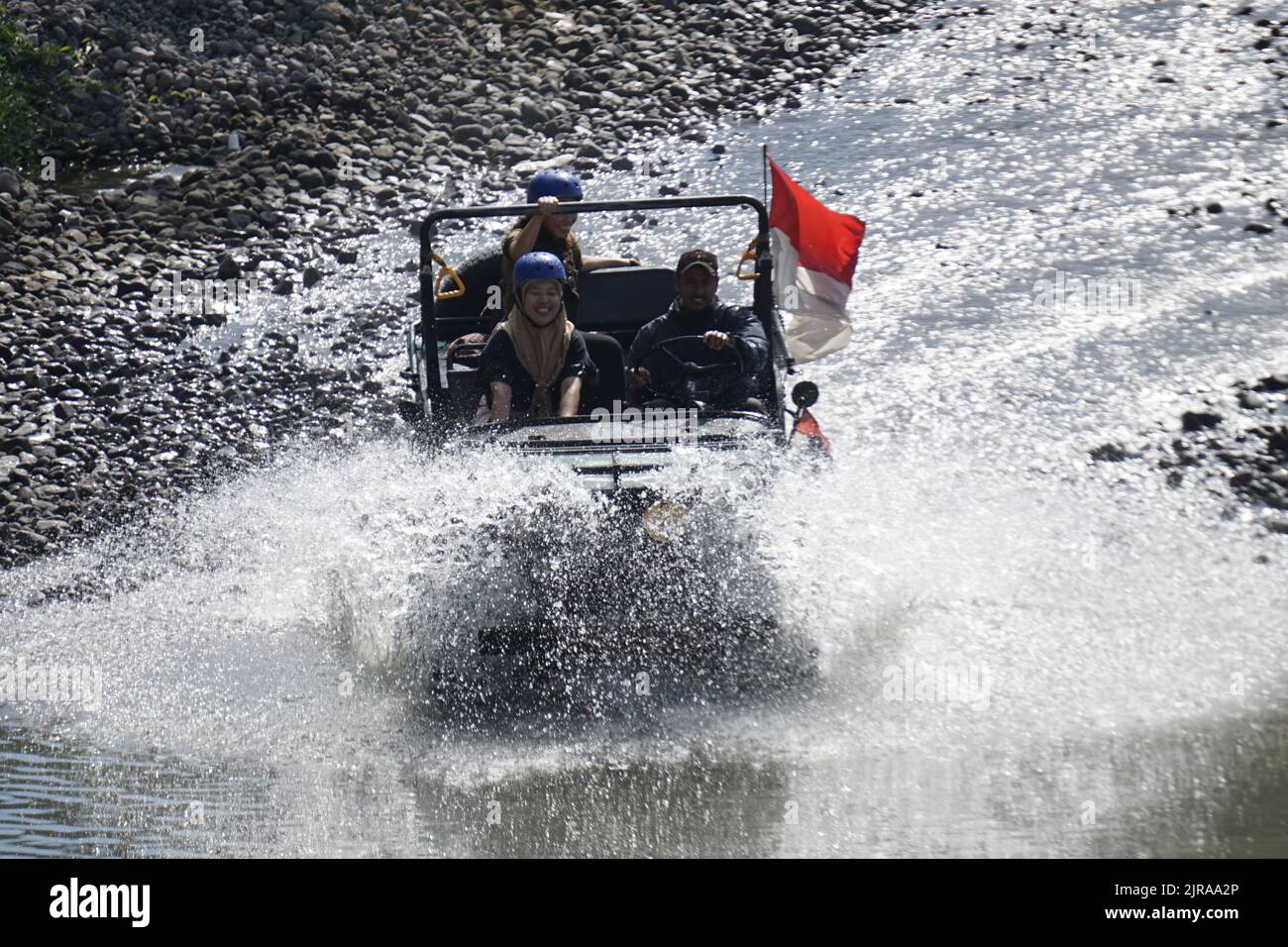 Offroad car brings tourists passing Kalikuning river in Sleman ...