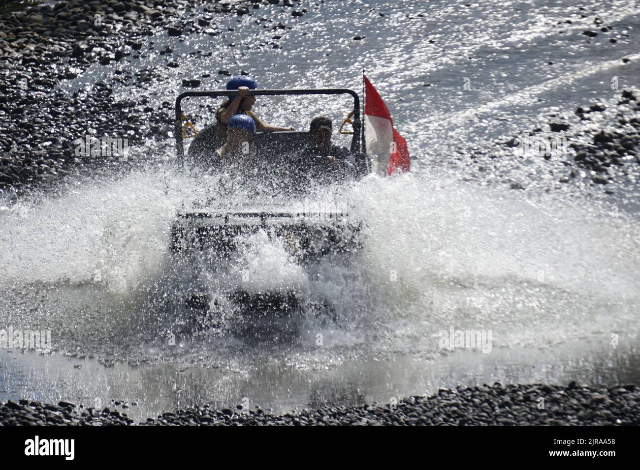 Offroad car brings tourists passing Kalikuning river in Sleman ...