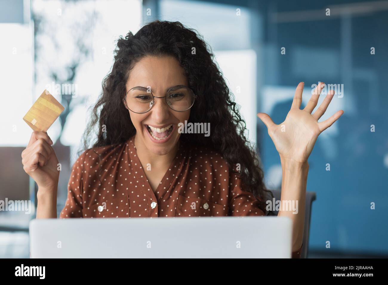 Close-up photo portrait of happy shocked woman, buyer holding bank ...
