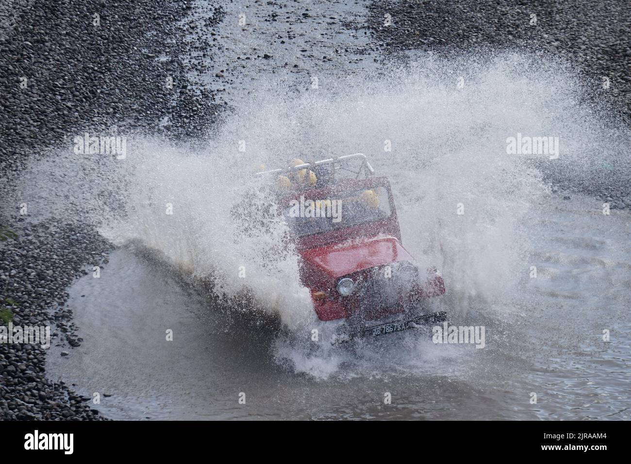 Offroad car brings tourists passing Kalikuning river in Sleman ...
