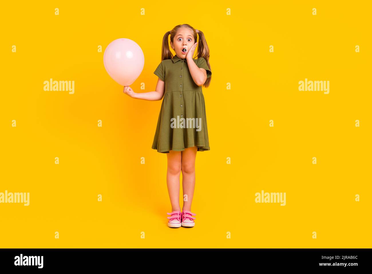 Full size photo of impressed funny person hold air balloon hand touch ...