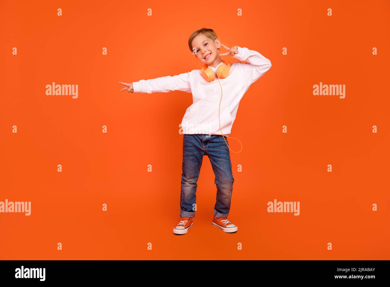 Full size photo of dynamic boy making v sign dancing stereo sound songs ...