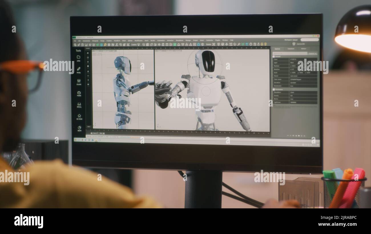 African American male creating 3D model of robot and rendering video for movie or computer game ...