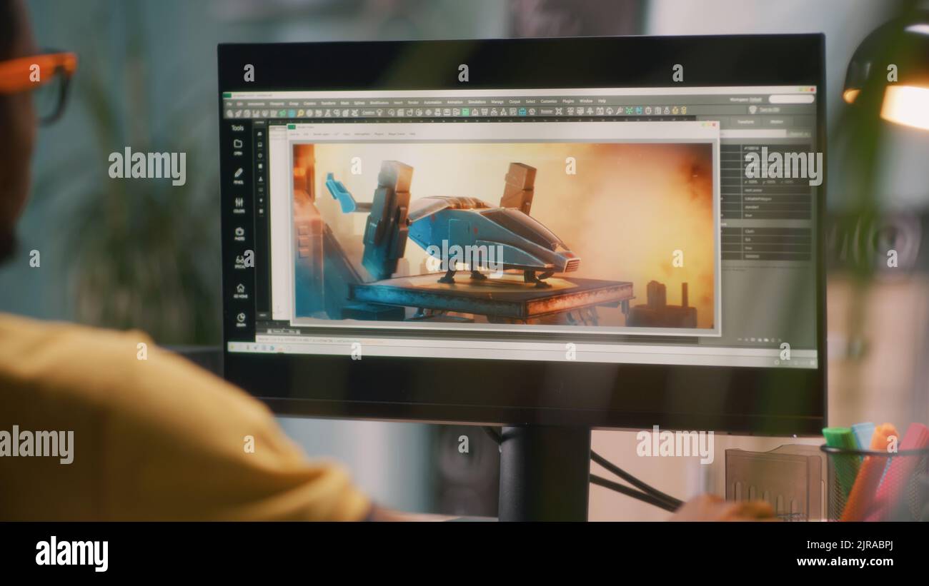 Crop black guy creating 3D model of futuristic aircraft on computer ...