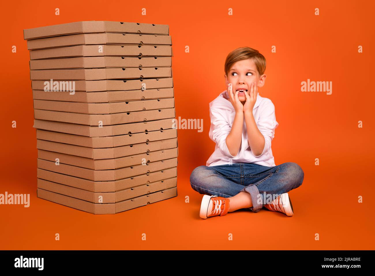 Full body photo of addicted boy sit floor look pile stack pizza offer ...