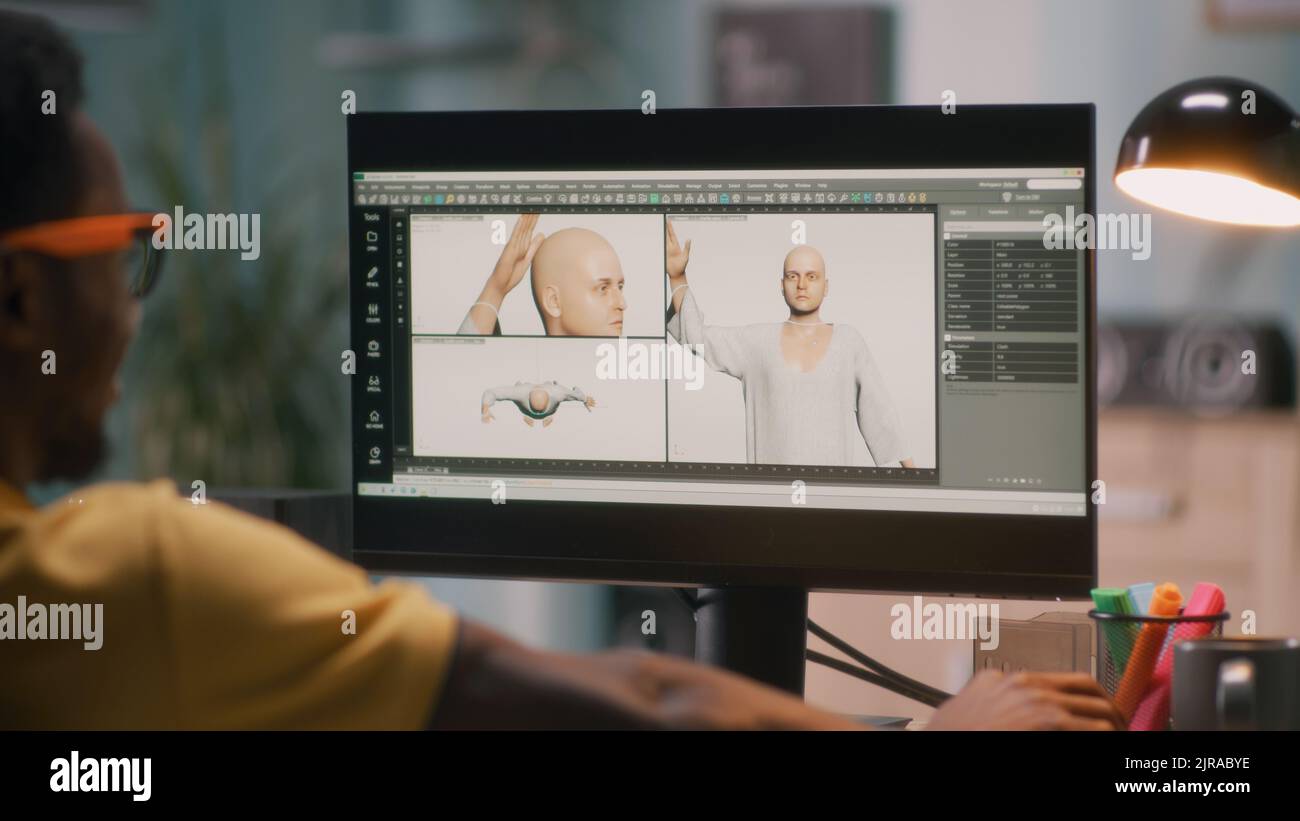 Black guy creating 3D model of bald human for movie or video game on computer during work in ...