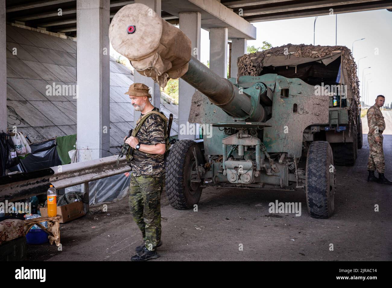 A Ukrainian soldier from the artillery battalion seen standing next to ...