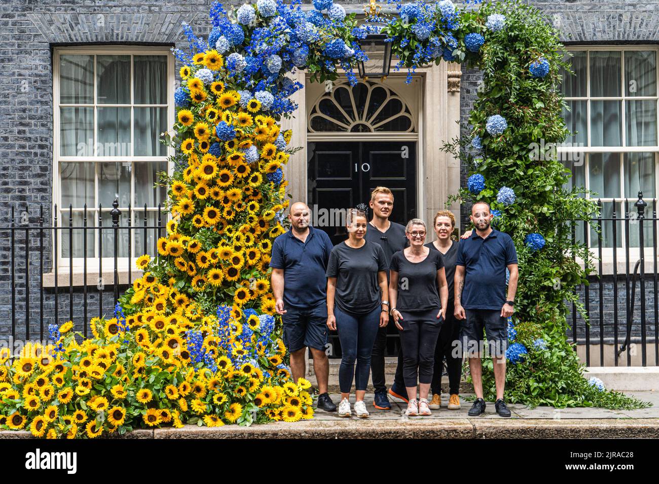 London, UK. 23 August 2022 . Florists pose at the door of 10 Downing ...
