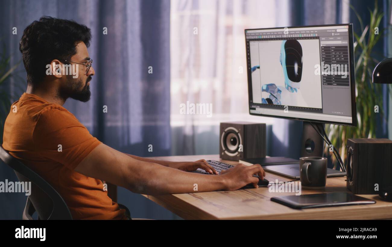 Indian male developer using computer to create and render 3D model of ...