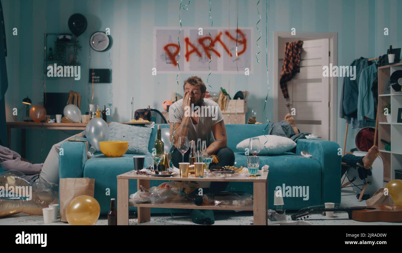 Bearded guy waking up and sitting down on couch then touching face ...