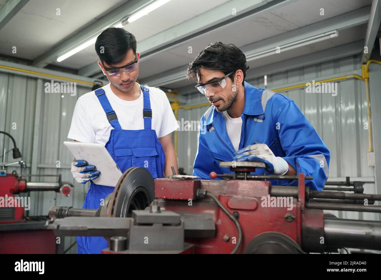 Workers changing and repair part of wheels at the car service Stock ...