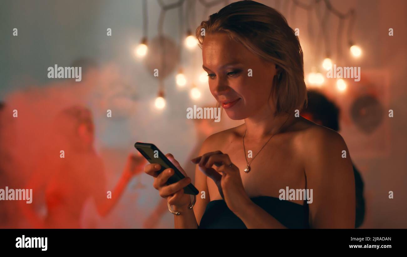Drunk blond female receiving and sending flirty text messages on ...
