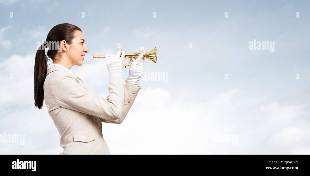 Beautiful woman playing trumpet brass Stock Photo - Alamy