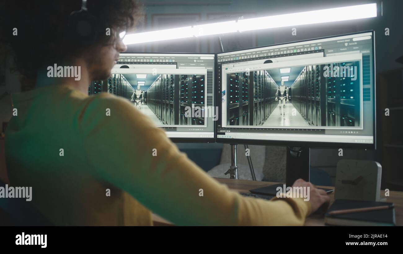 Male 3D designer creating animation of walking robot on computer while ...