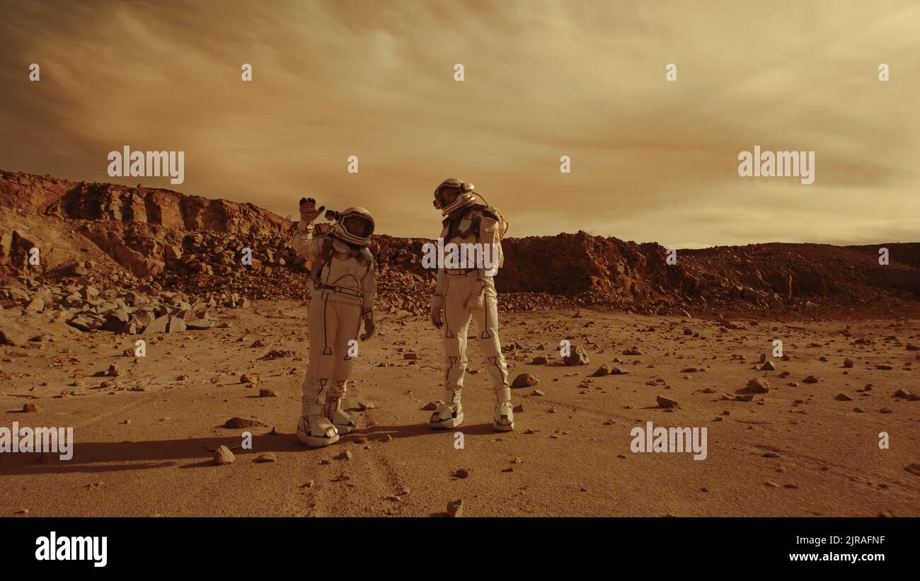 Zoom out view of people in spacesuits discussing base location while ...