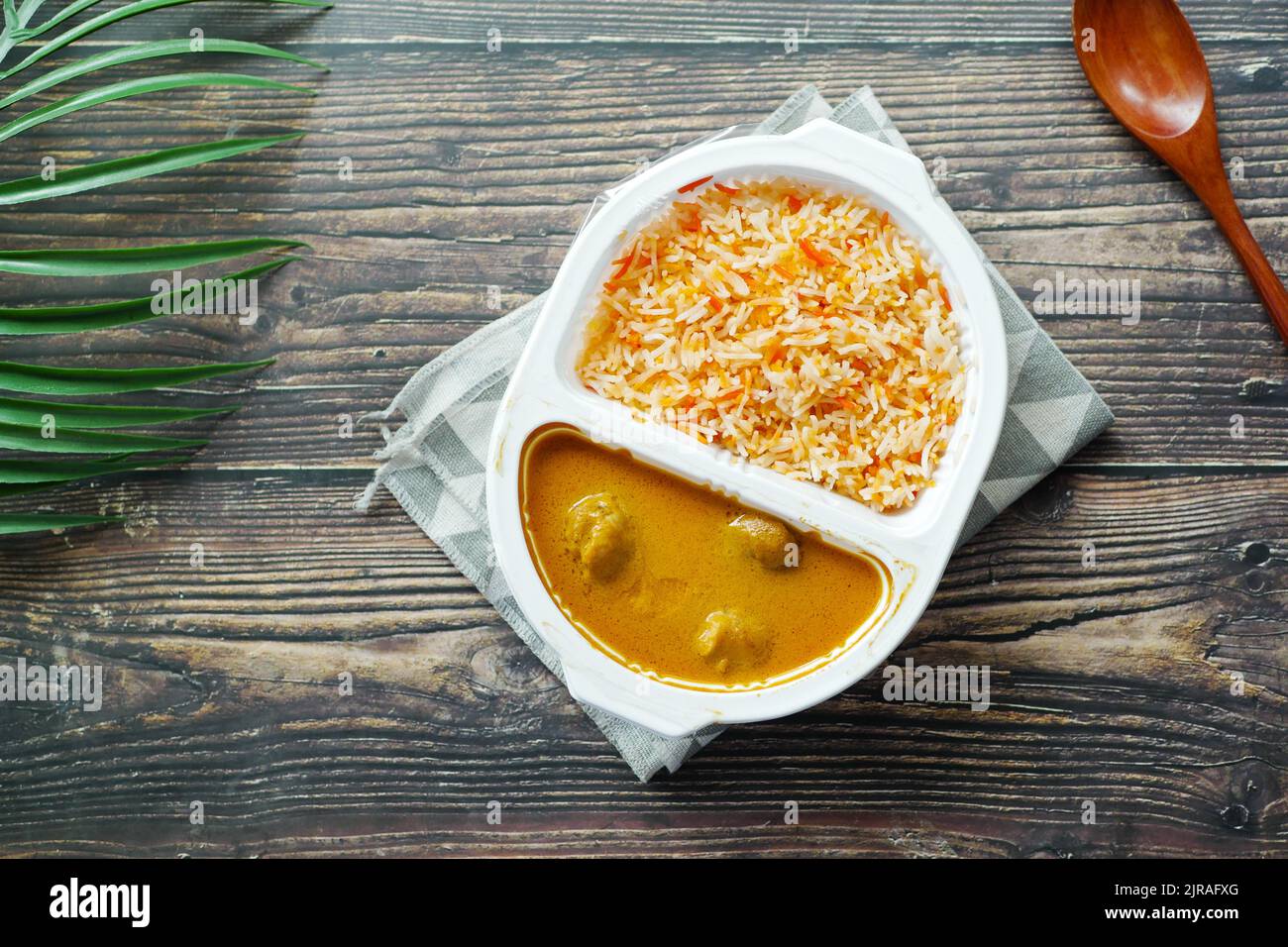 curry chicken and rice in a take away plastic packet on table Stock ...
