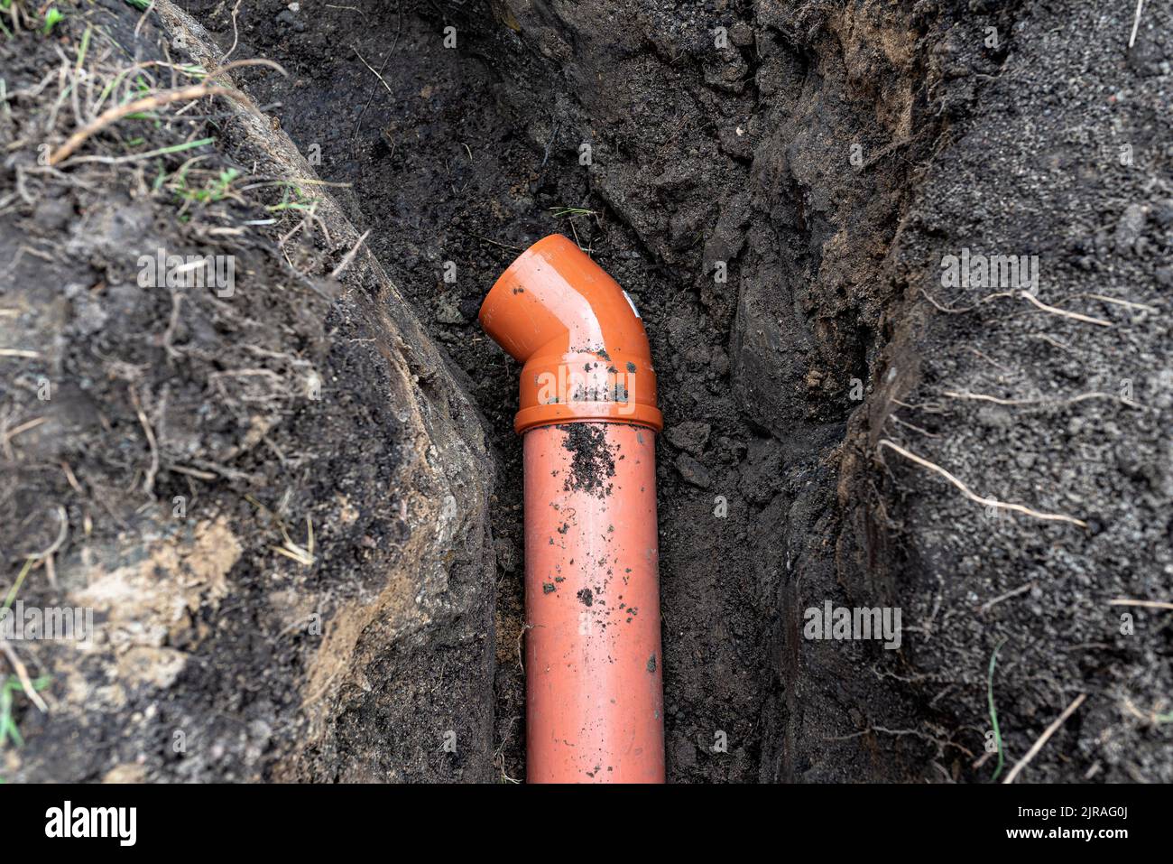 An orange plastic pipe from a septic tank with a diameter of 160 mm ...