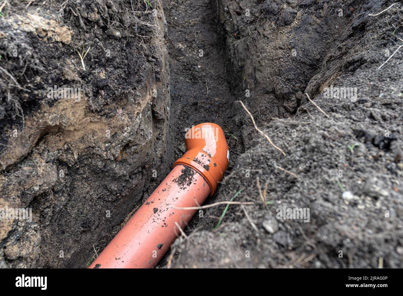 An orange plastic pipe from a septic tank with a diameter of 160 mm ...