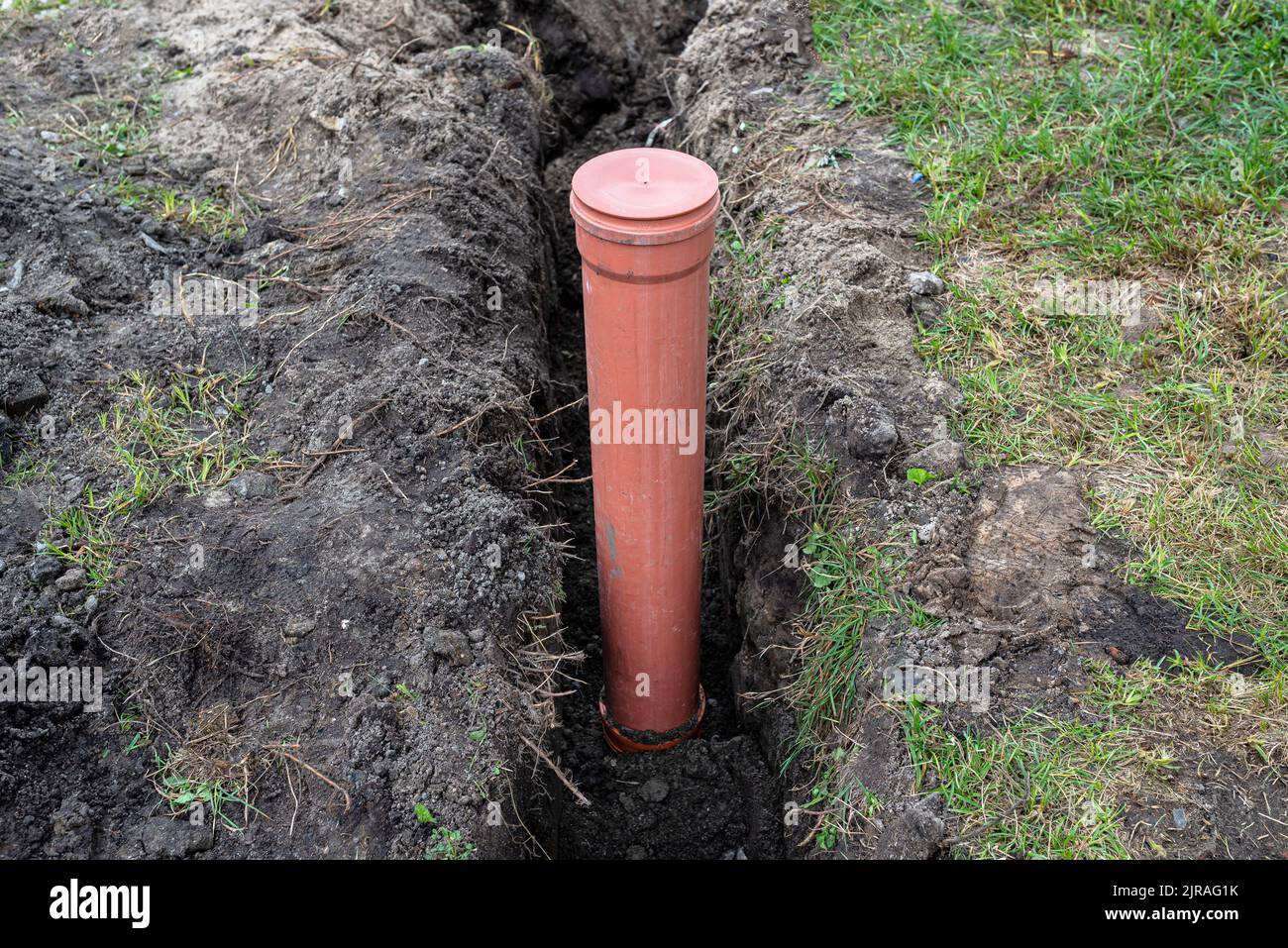 An orange plastic pipe from a septic tank with a diameter of 160 mm ...