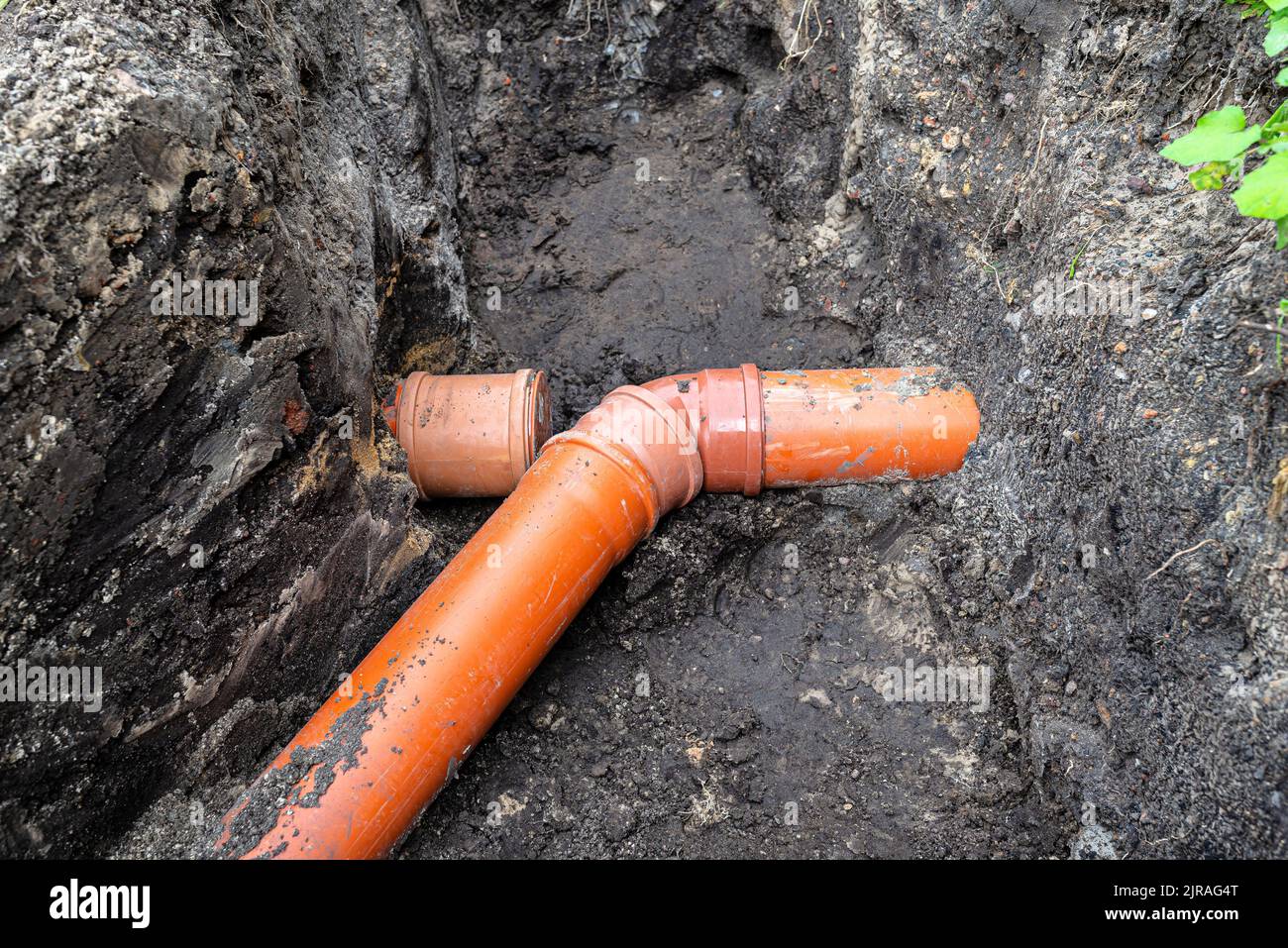 An orange plastic pipe from a septic tank with a diameter of 160 mm ...