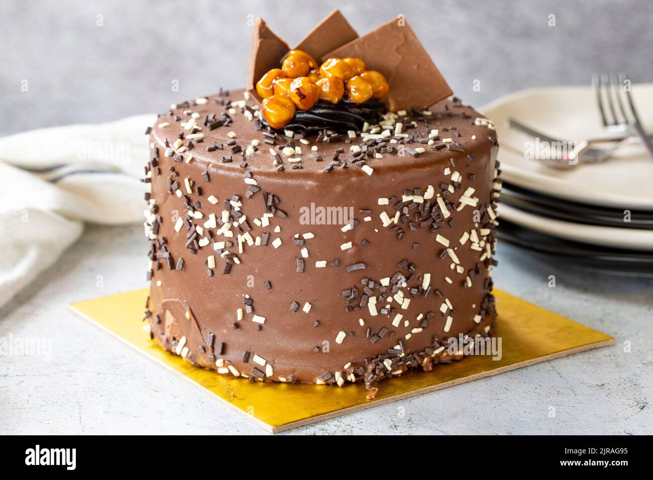 Birthday cake with croquant on gray background. Chocolate covered cake ...