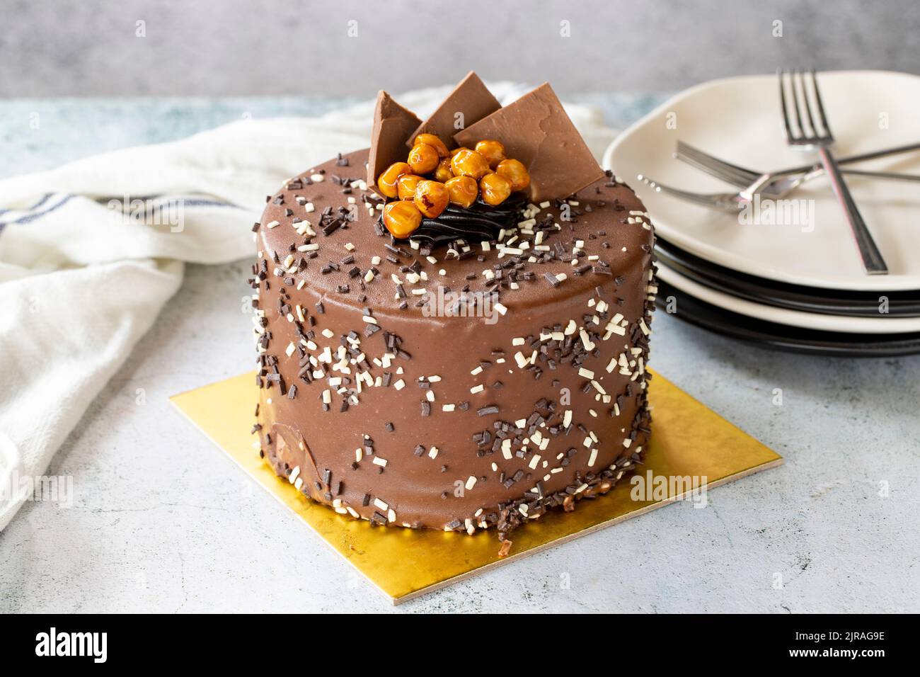 Birthday cake with croquant on gray background. Chocolate covered cake ...