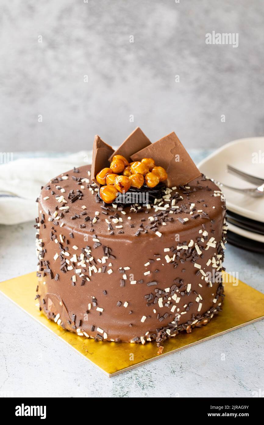 Birthday cake with croquant on gray background. Chocolate covered cake ...