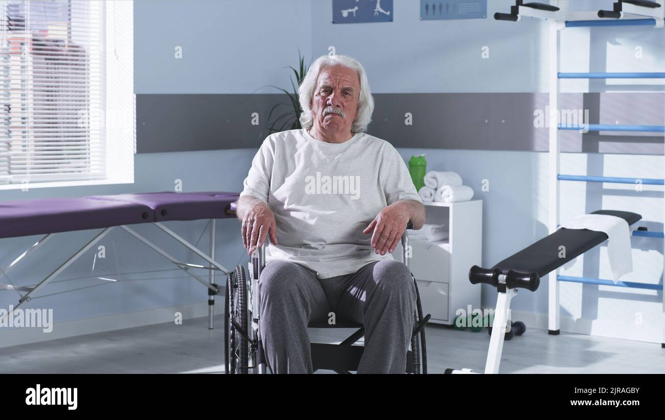 Elderly male patient with disability sitting on wheelchair in ...