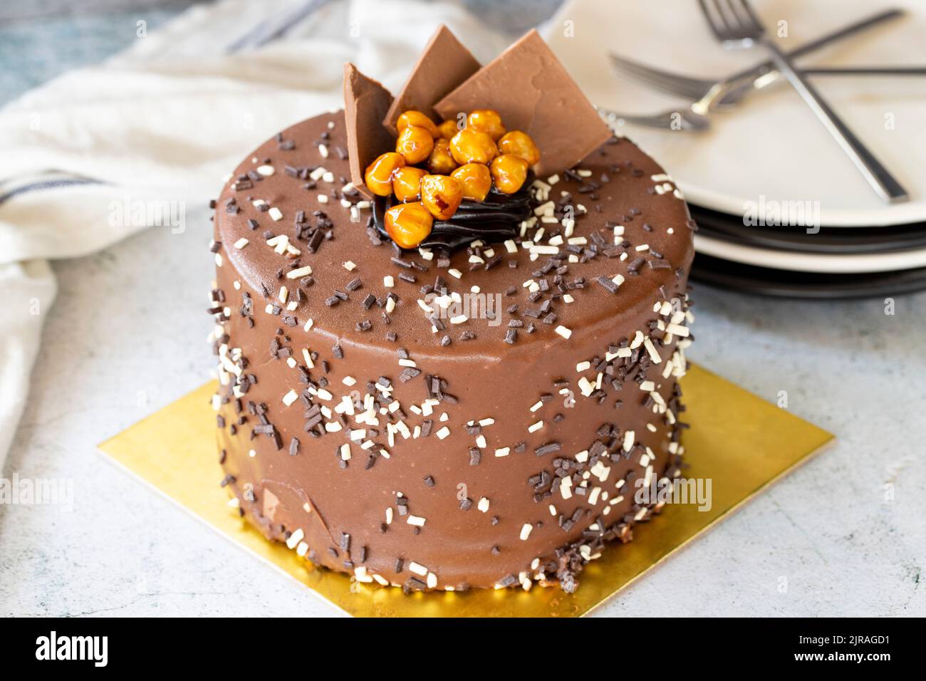 Birthday cake with croquant on gray background. Chocolate covered cake ...
