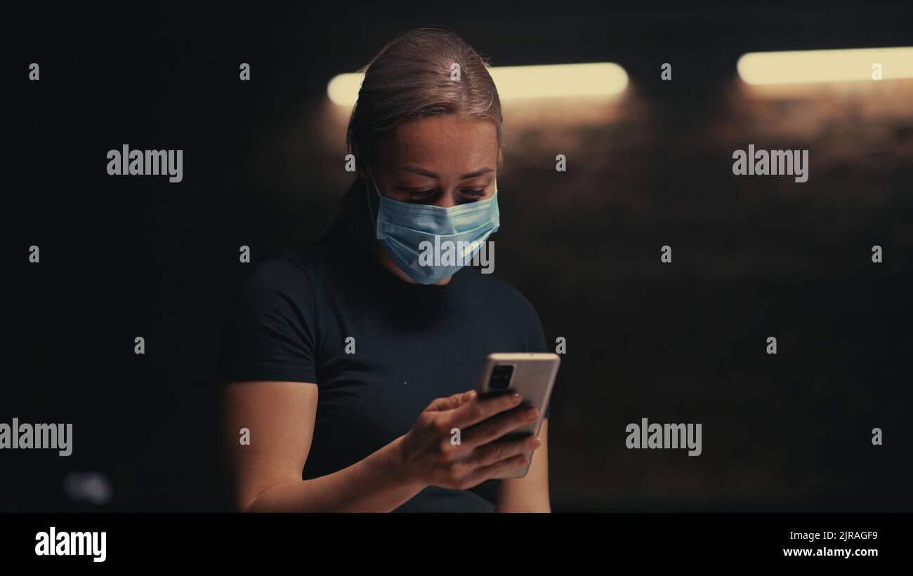 Female in black t shirt taking off mask and talking with online friends ...