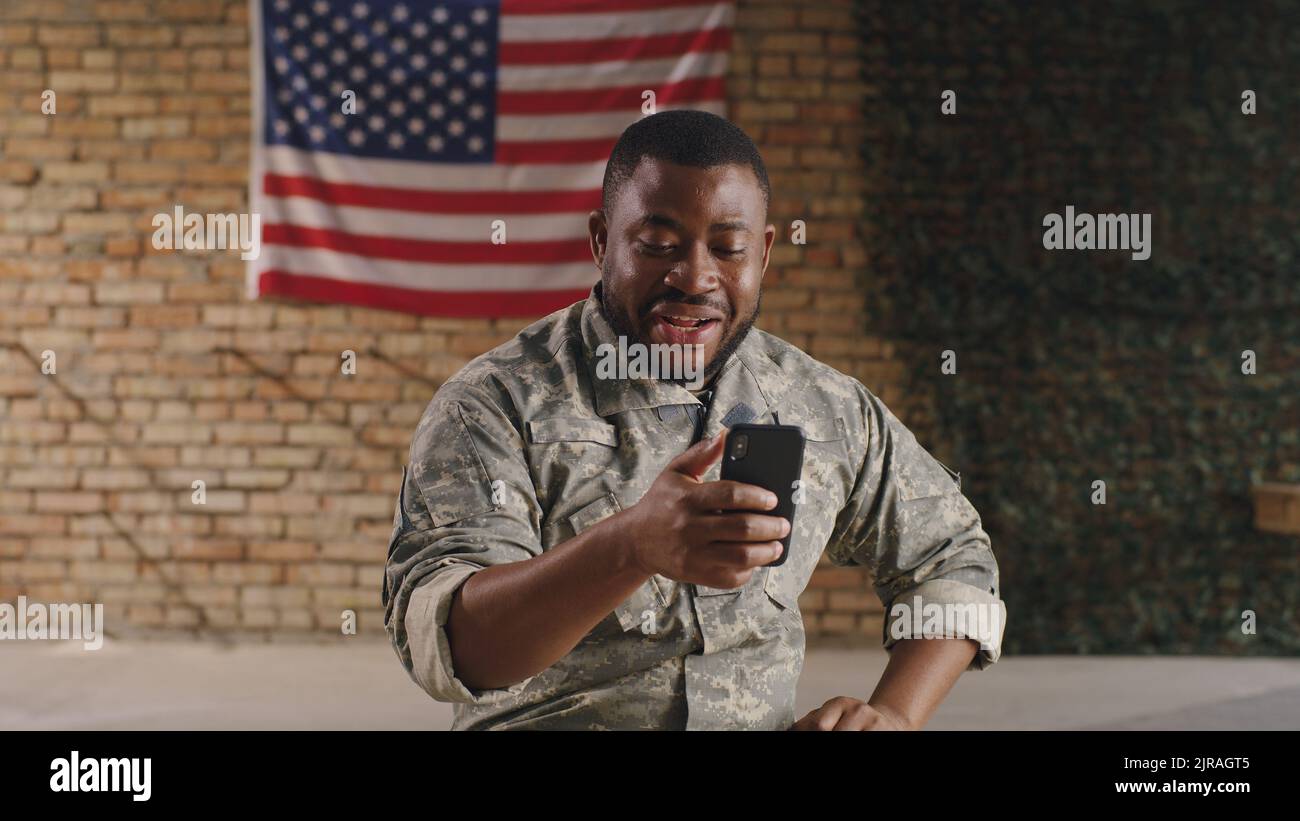 African American commander in camouflage speaking and pointing at ...