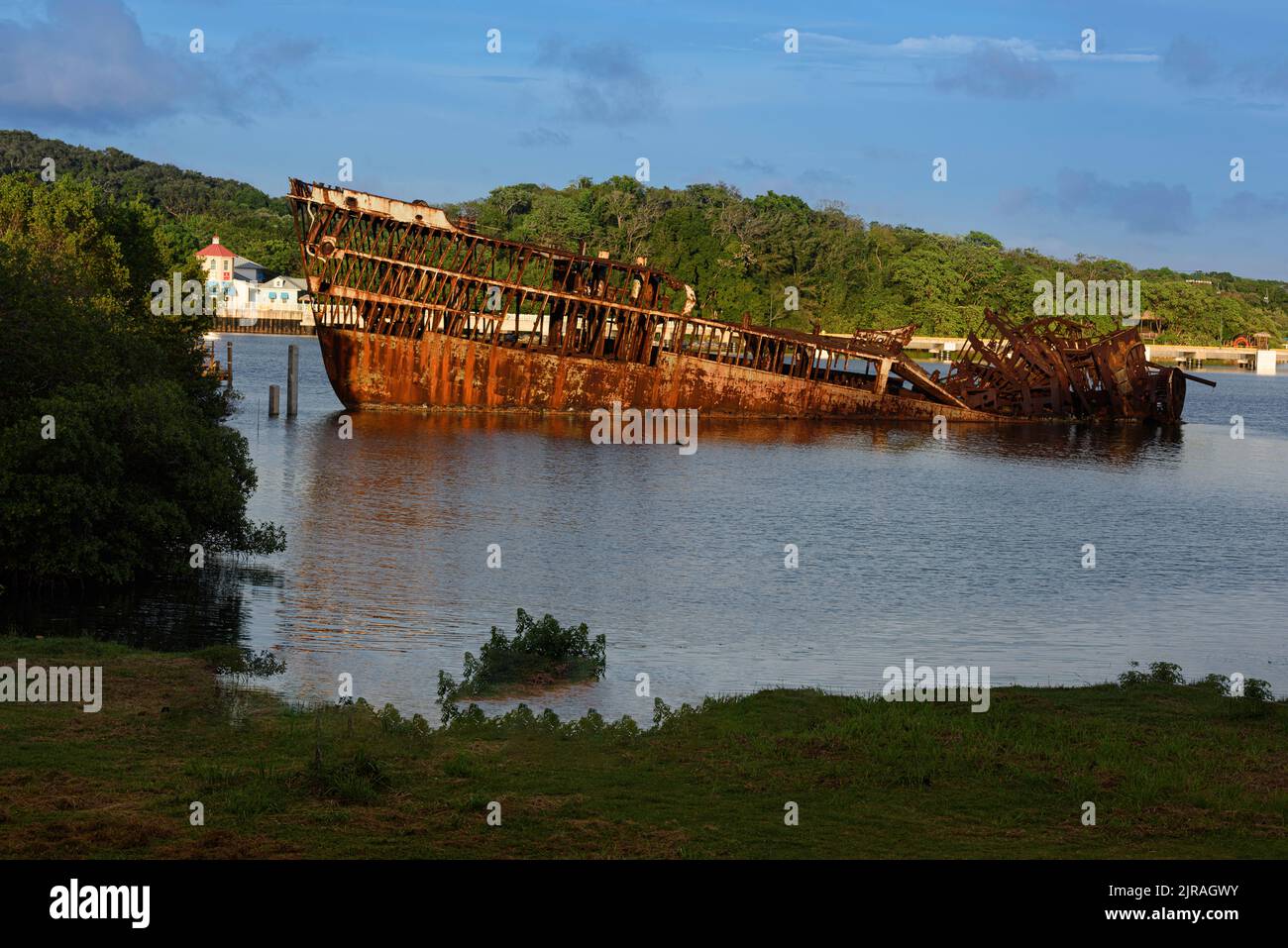 Old rusted shipwreck on a tropical island harbor Stock Photo - Alamy
