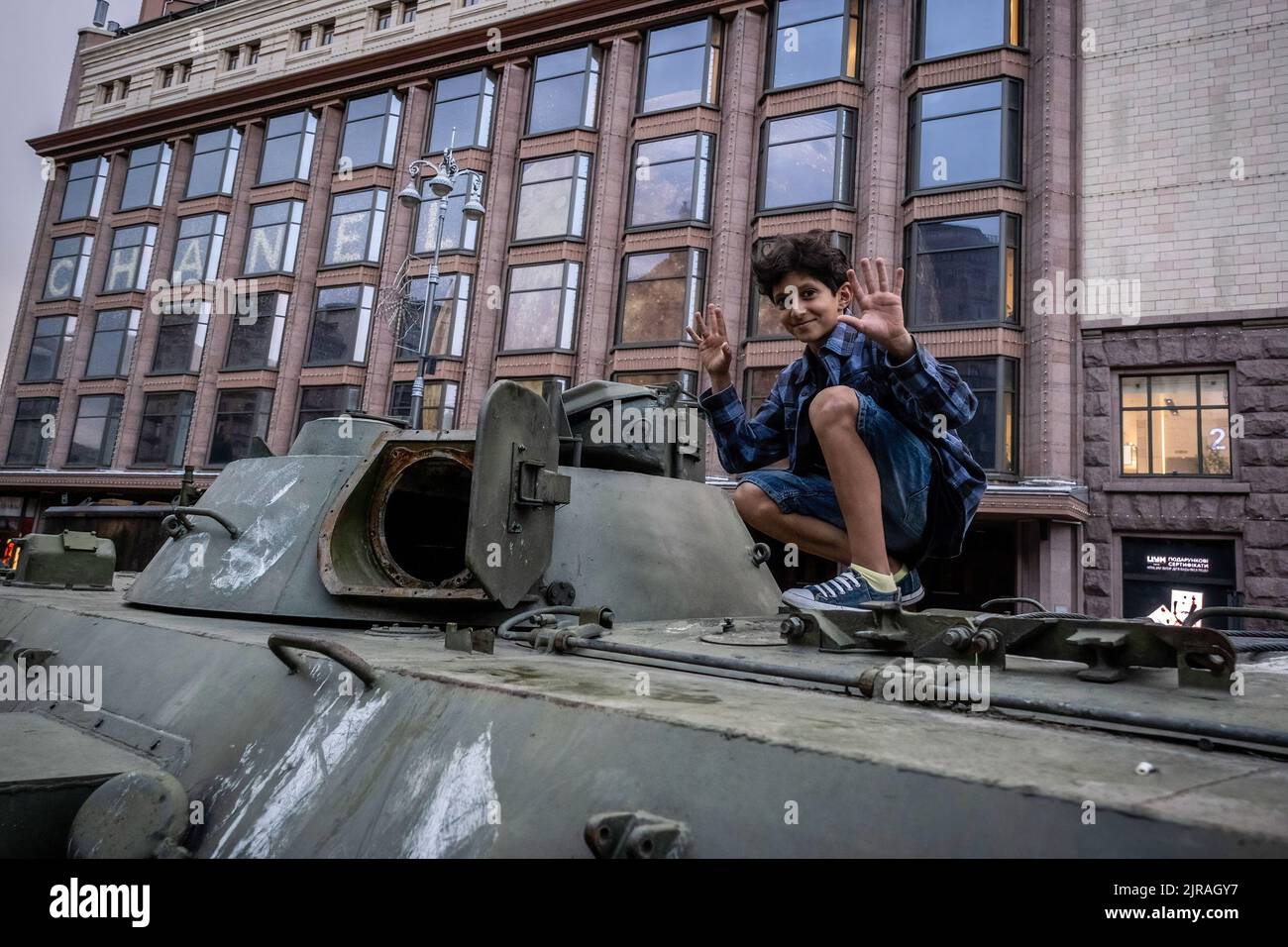 A boy seen posing for a photo on a destroyed Russian Armoured Vehicle ...