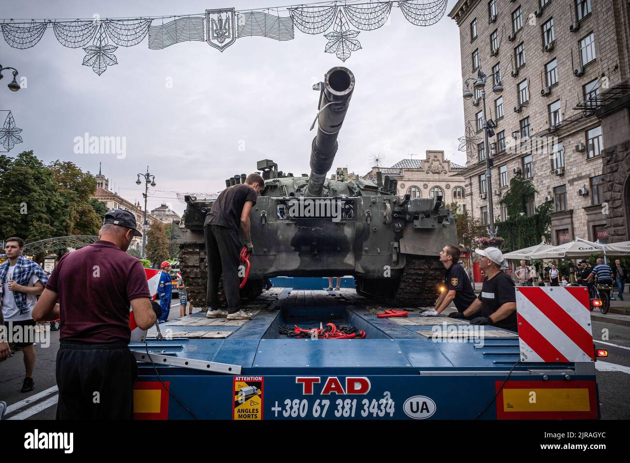 Workers transport the wreckage of a Russian tank to the exhibition in ...