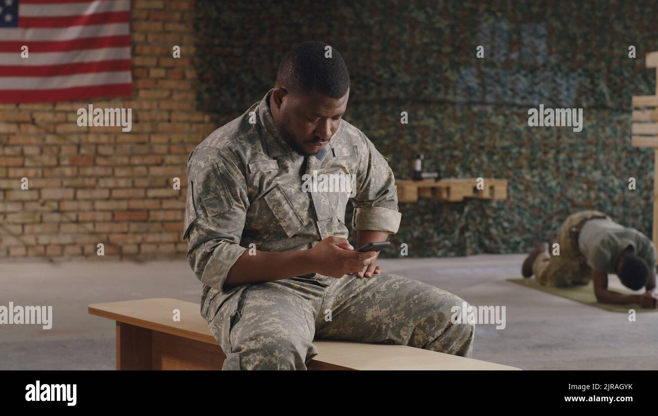 African American soldier finishing plank exercise and coming closer to ...